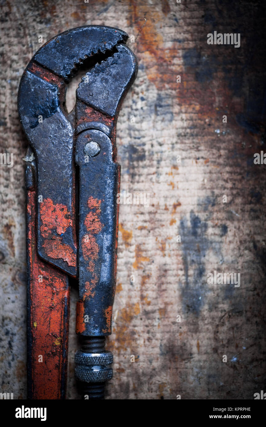 Adjustable spanner on wooden plank Stock Photo - Alamy