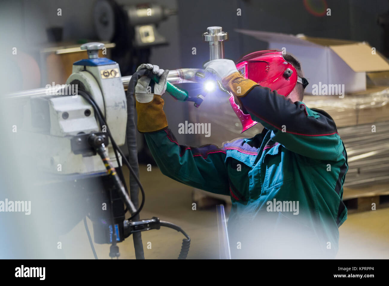 Industrial worker welding in metal factory Stock Photo - Alamy
