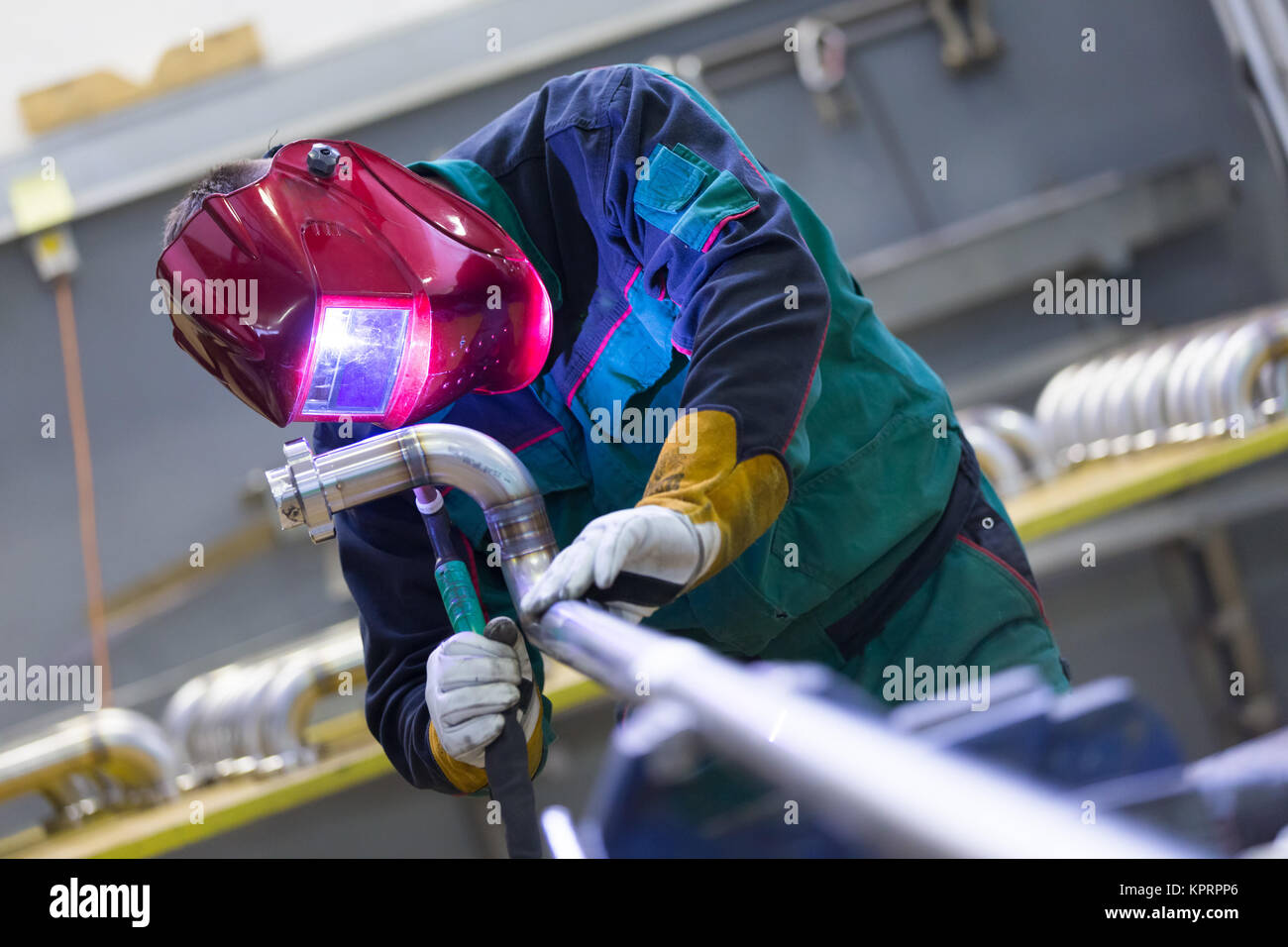 Industrial worker welding in metal factory Stock Photo - Alamy
