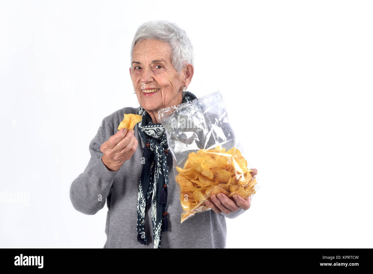 Old woman eating chips hi-res stock photography and images - Alamy