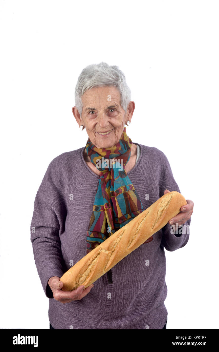senior woman eating bread on white background Stock Photo - Alamy