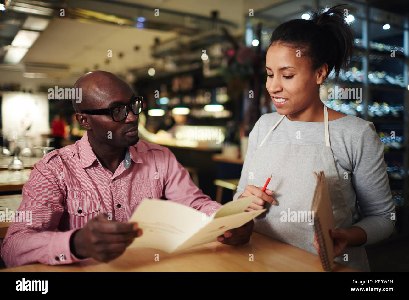 Woman restaurant ordering food waiter hi-res stock photography and ...