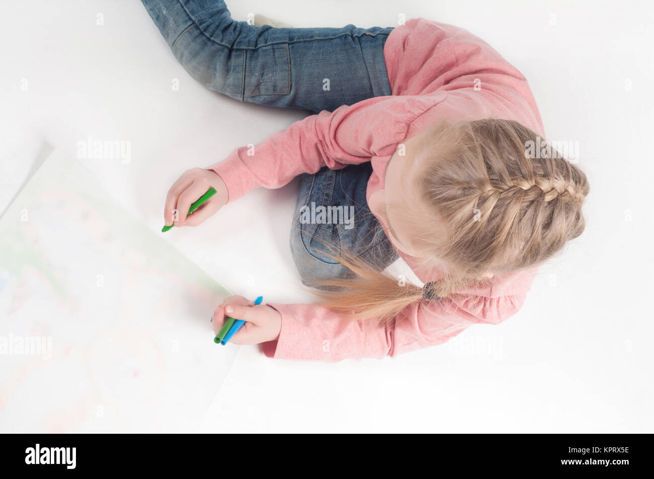 View from above to drawing little girl Stock Photo - Alamy