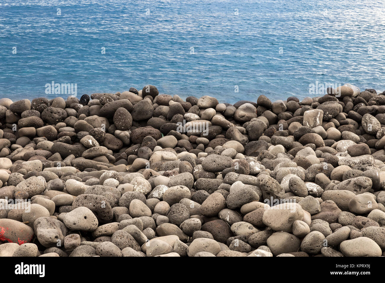 Volcanic rock beach and sea- ideal for backgrounds Stock Photo - Alamy