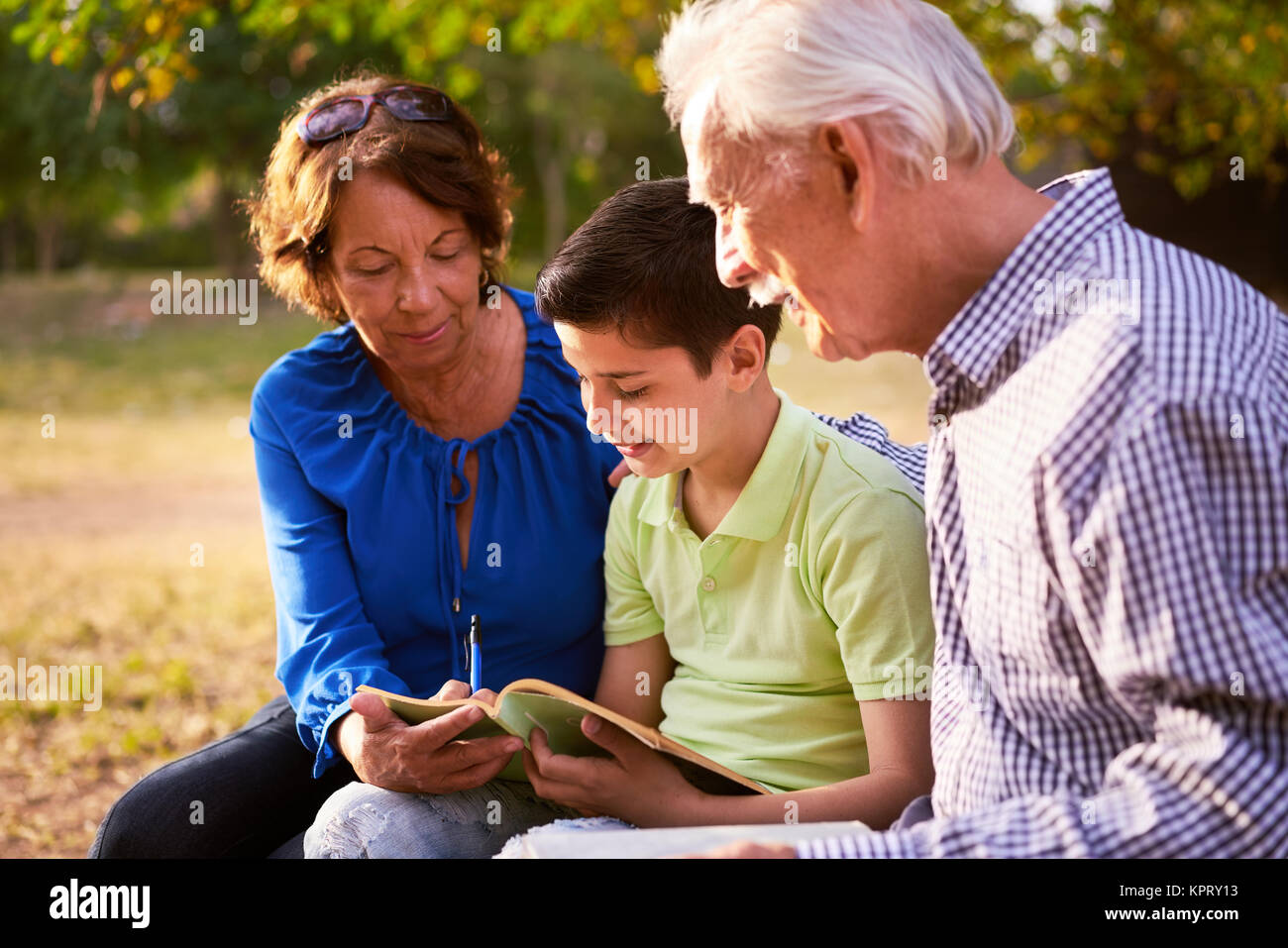 Grandparents Helping Child Doing School Homework Stock Photo - Alamy