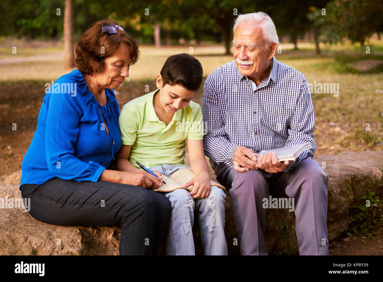 Grandpa And Grandma Helping Boy With Homework Stock Photo - Alamy