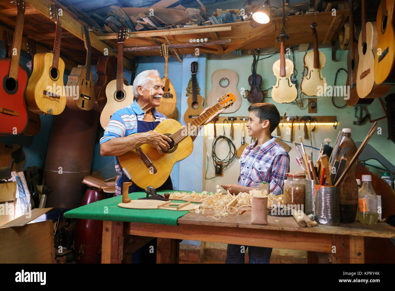 Old Man Grandpa Teaching Boy Grandchild Playing Guitar Stock Photo - Alamy