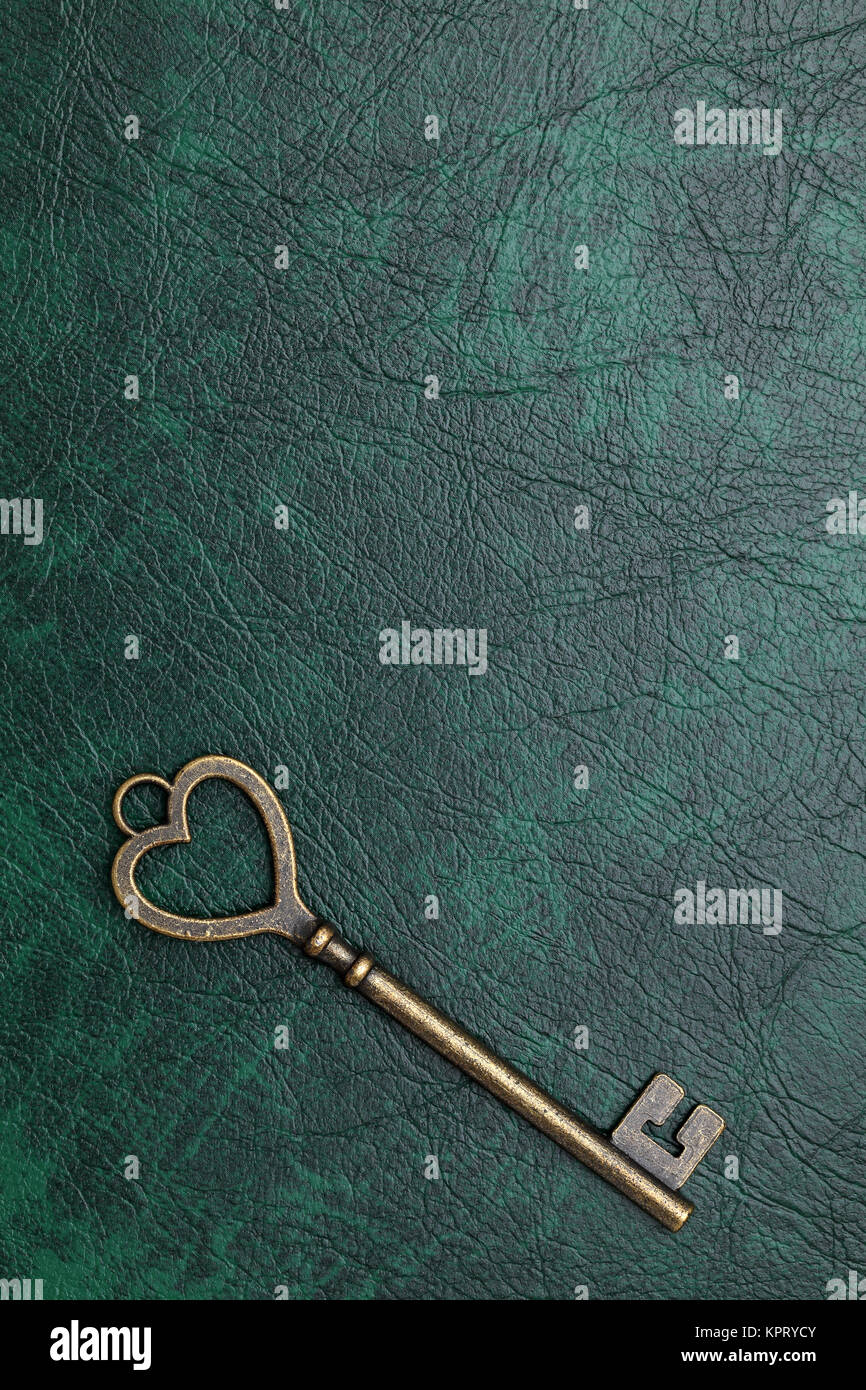 vintage key heart shape on green leather background Stock Photo - Alamy
