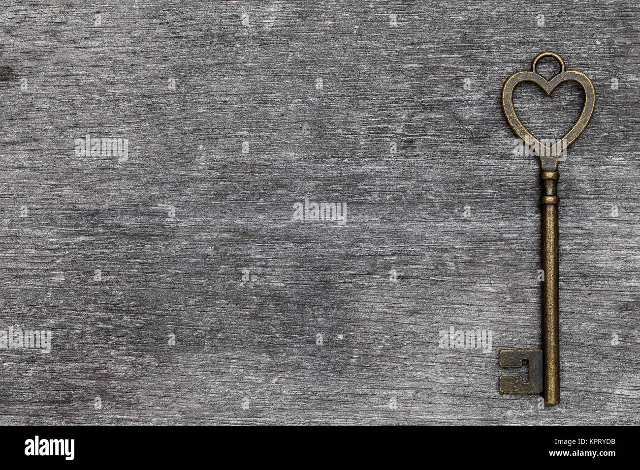 vintage key heart shape on grunge wooden background Stock Photo - Alamy