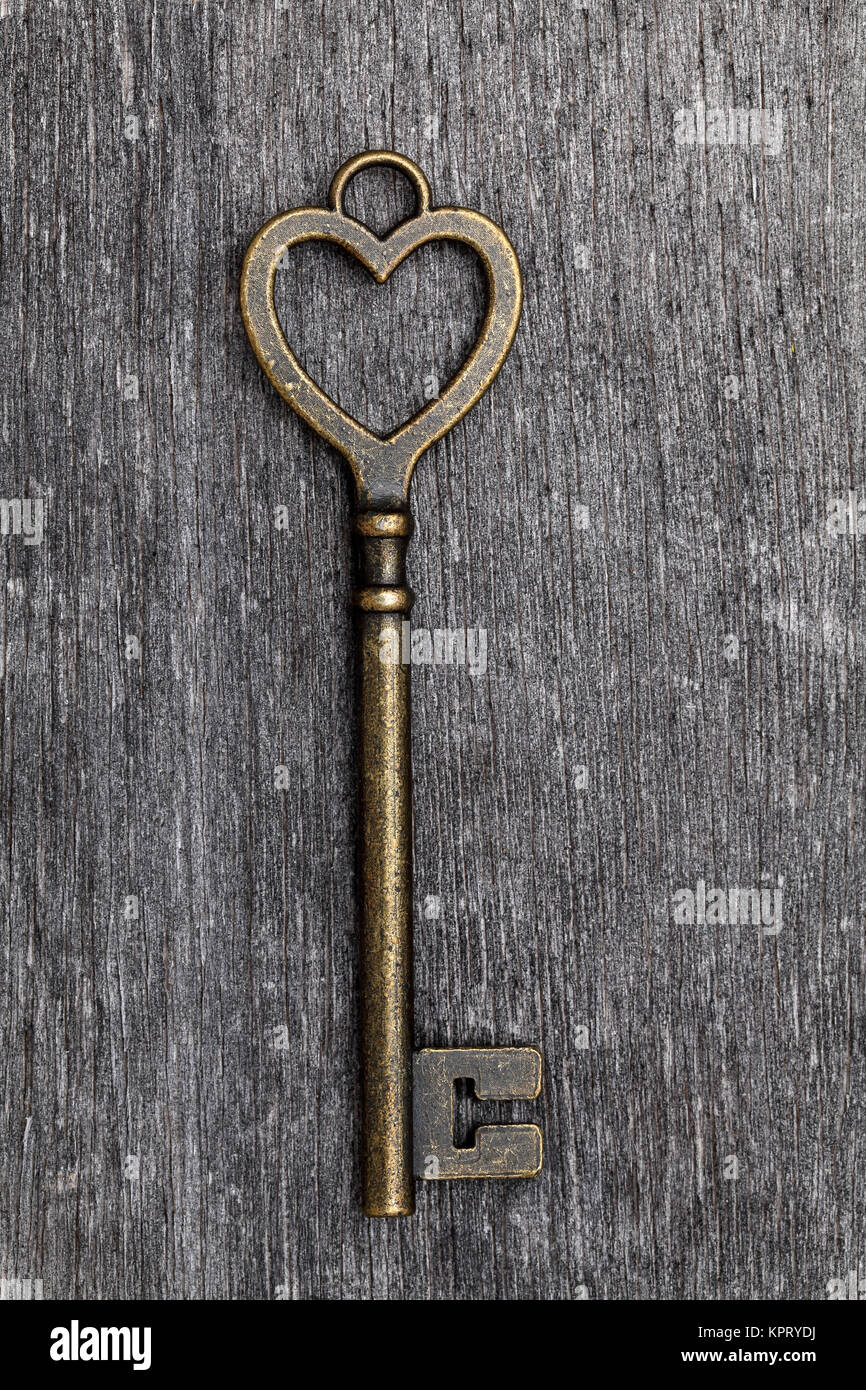 vintage key heart shape on grunge wooden background Stock Photo - Alamy