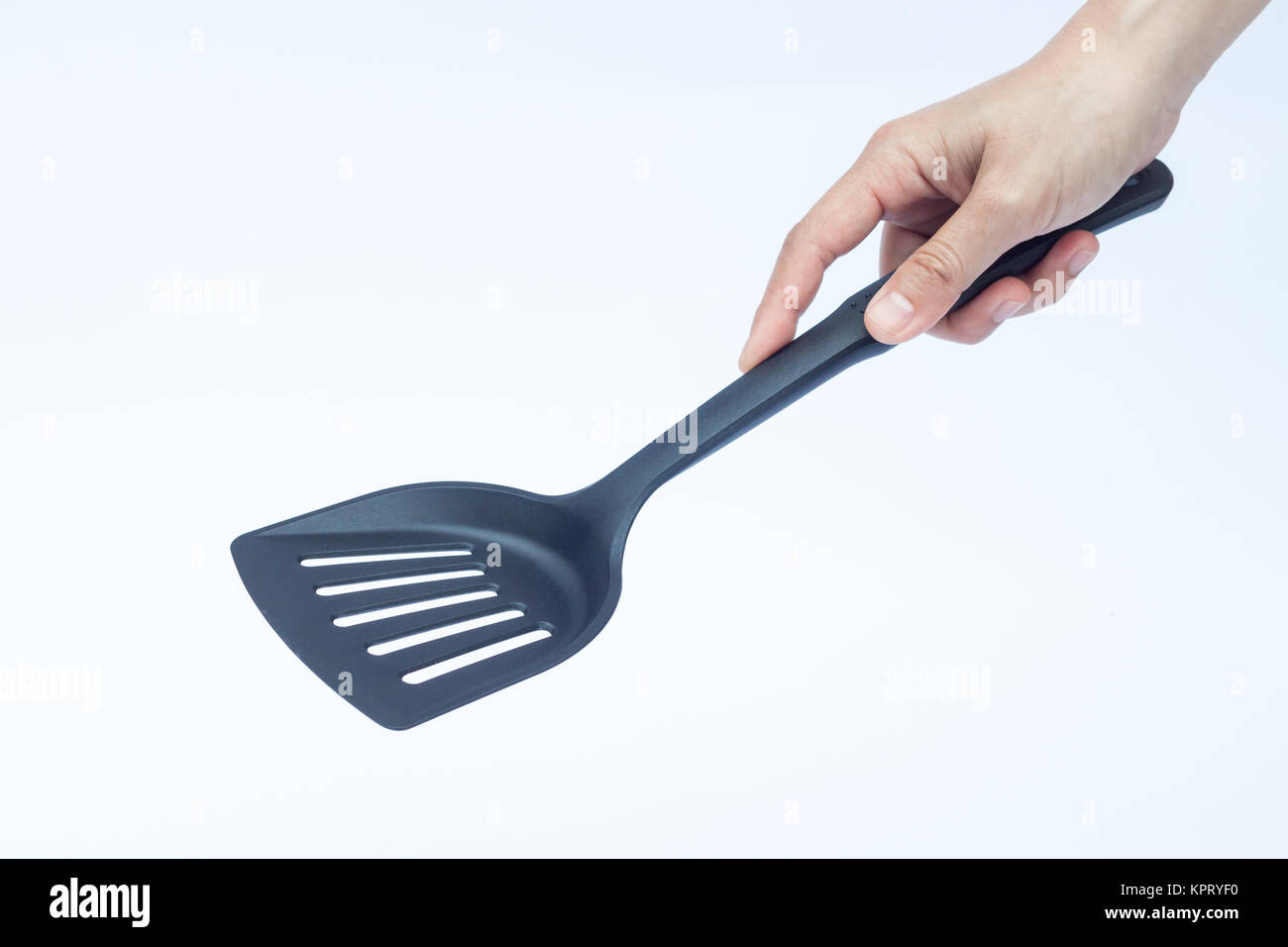 Black plastic kitchen spatula on white background Stock Photo - Alamy