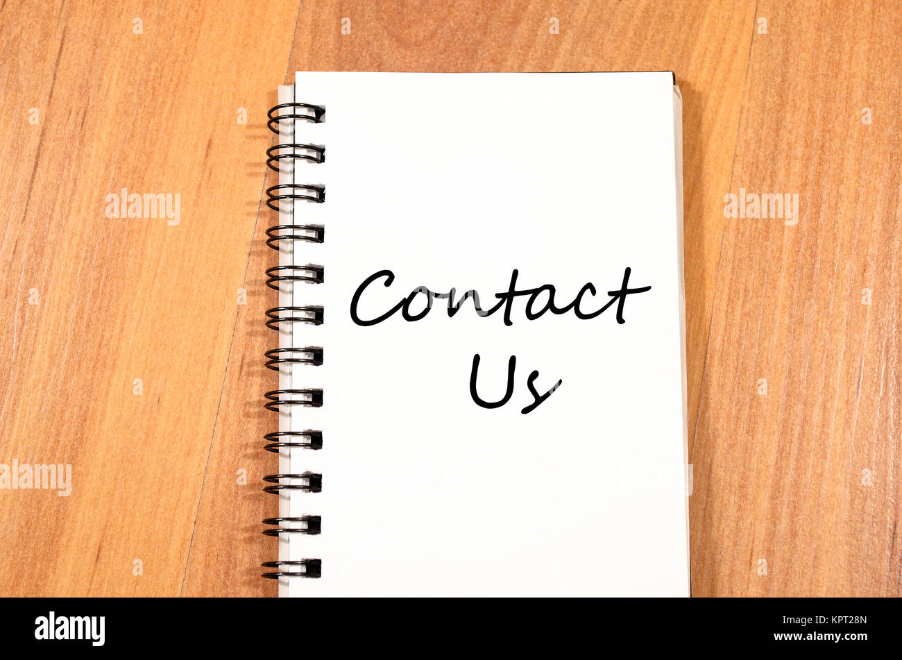 Contact us write on notebook Stock Photo - Alamy