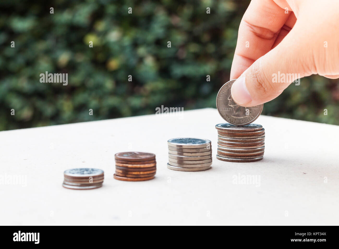Woman hand putting money coin for saving money concept Stock Photo - Alamy