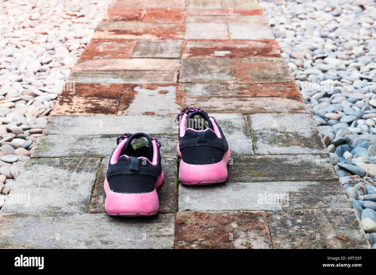 Running shoes in home garden foot path, stock photo Stock Photo - Alamy