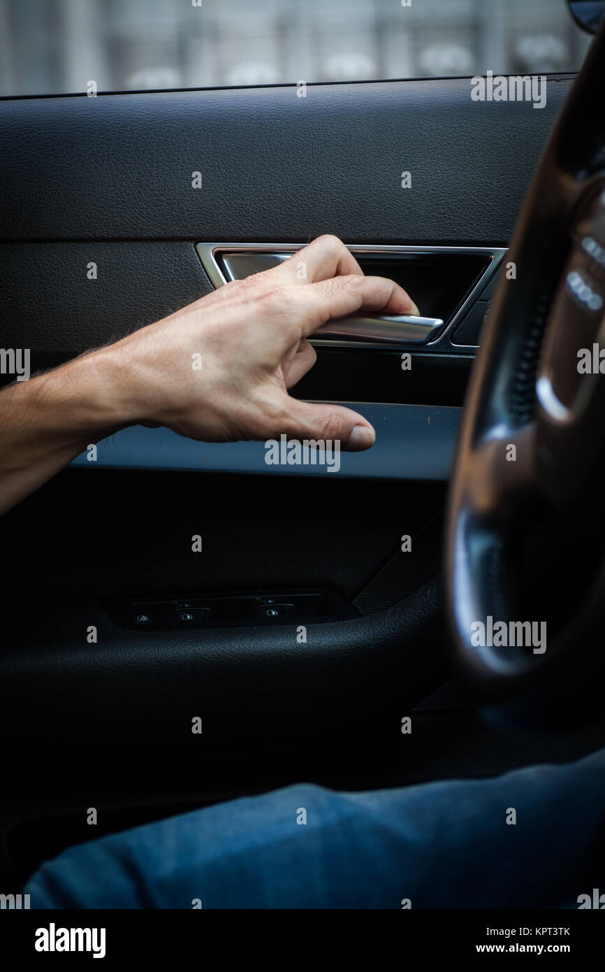 Close up image a hand opening a car door from inside Stock Photo - Alamy