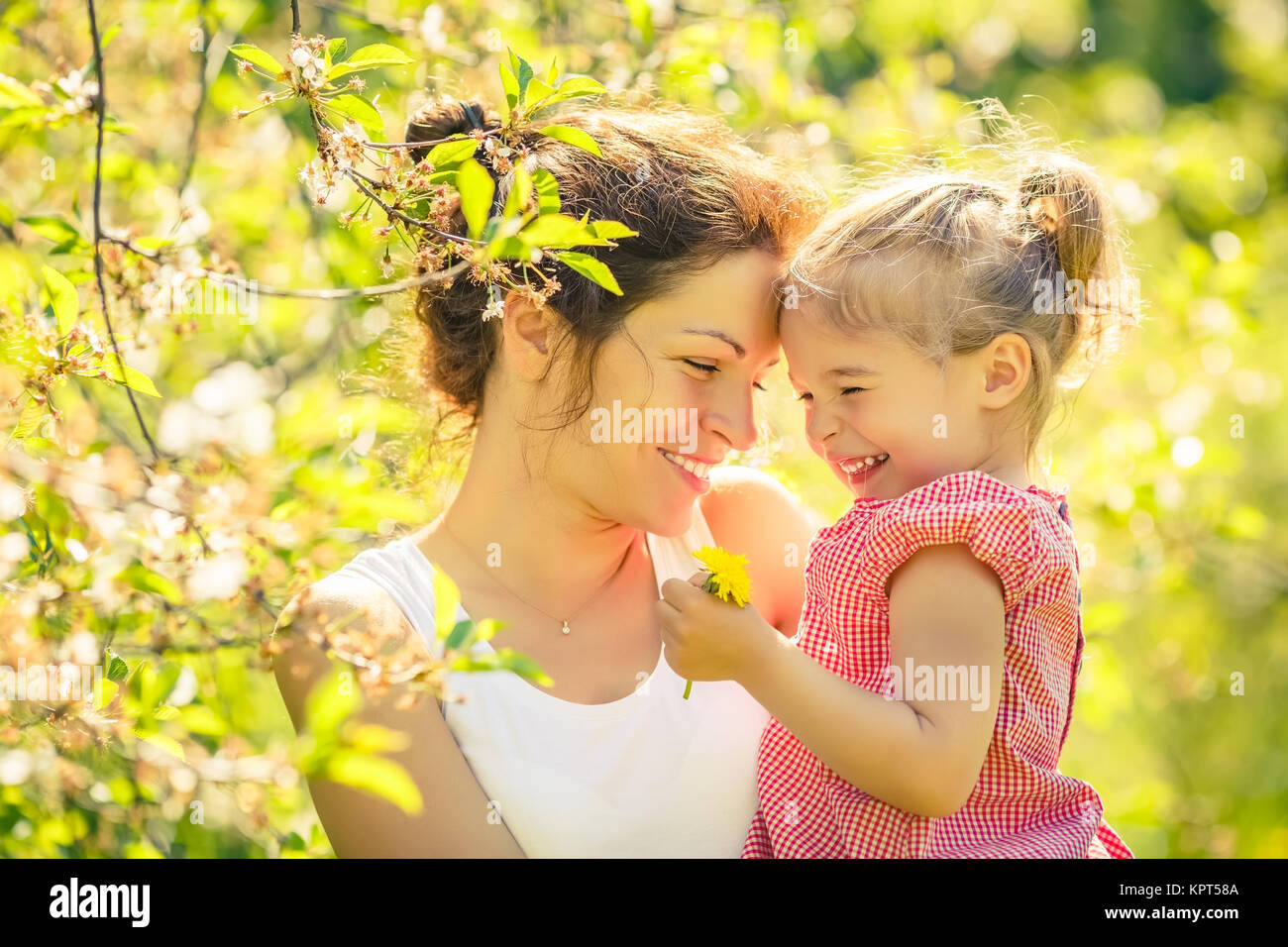 Mother and daughter in spring sunny park Stock Photo - Alamy