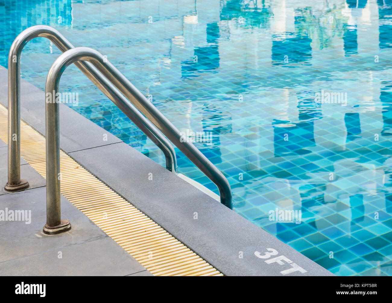 Swimming pool with metal handrail stair Stock Photo - Alamy