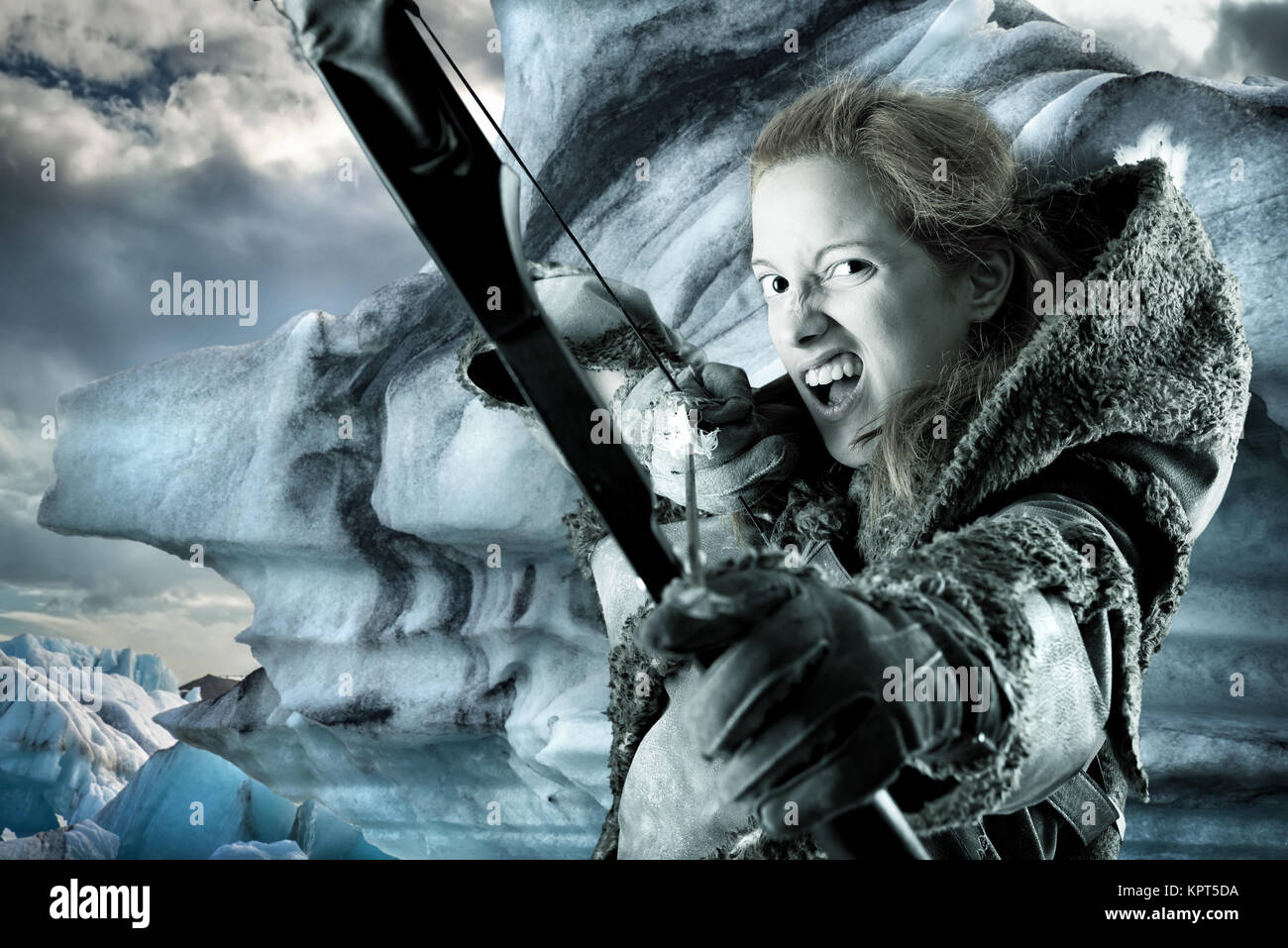 Wild girl archer in the snow with bow Stock Photo - Alamy