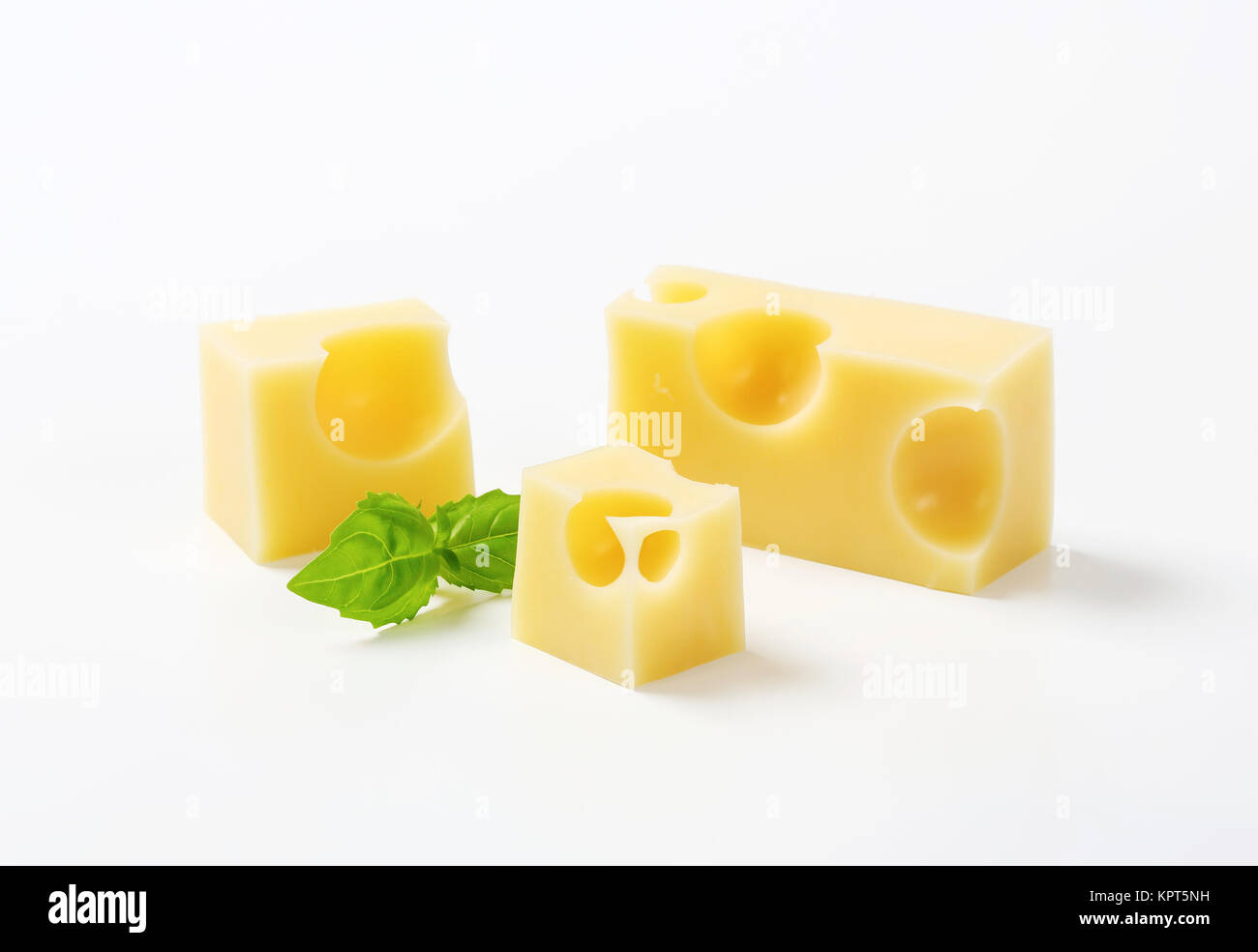 pieces of emmental cheese on white background Stock Photo - Alamy