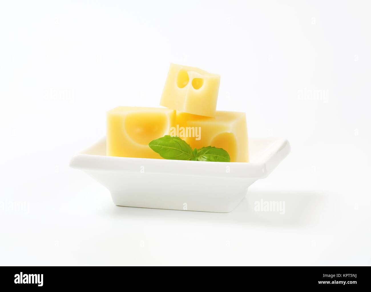 cubes of emmental cheese in white bowl Stock Photo - Alamy