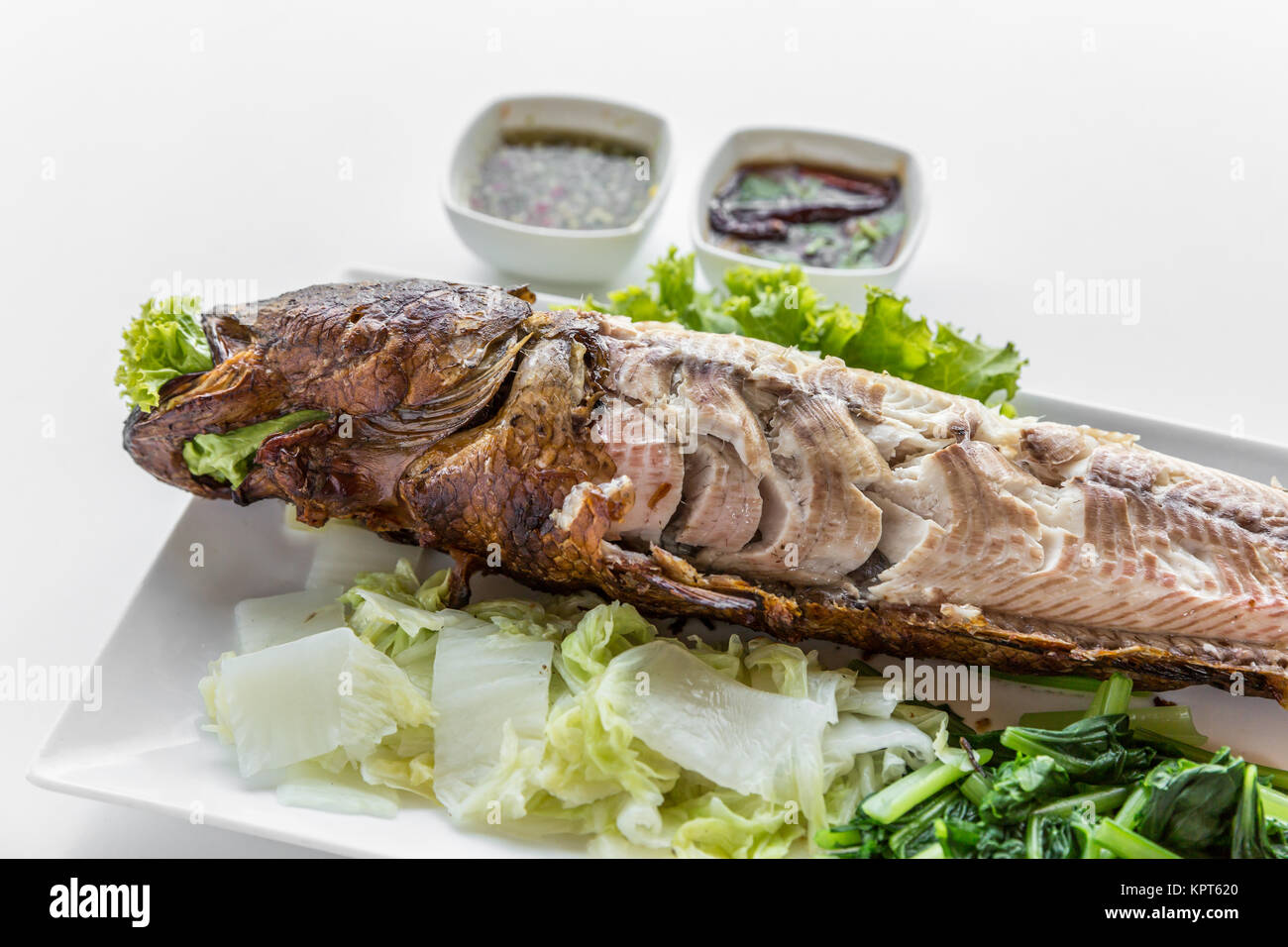Grilled fish with vegetable and sauce on white background Stock Photo ...