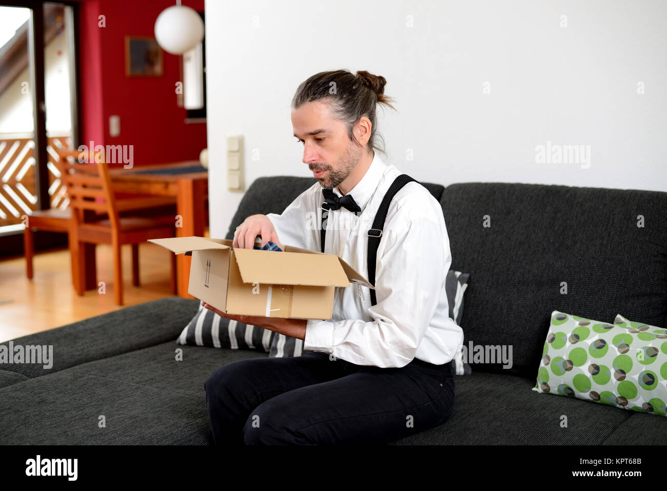 angry man opening a package Stock Photo - Alamy