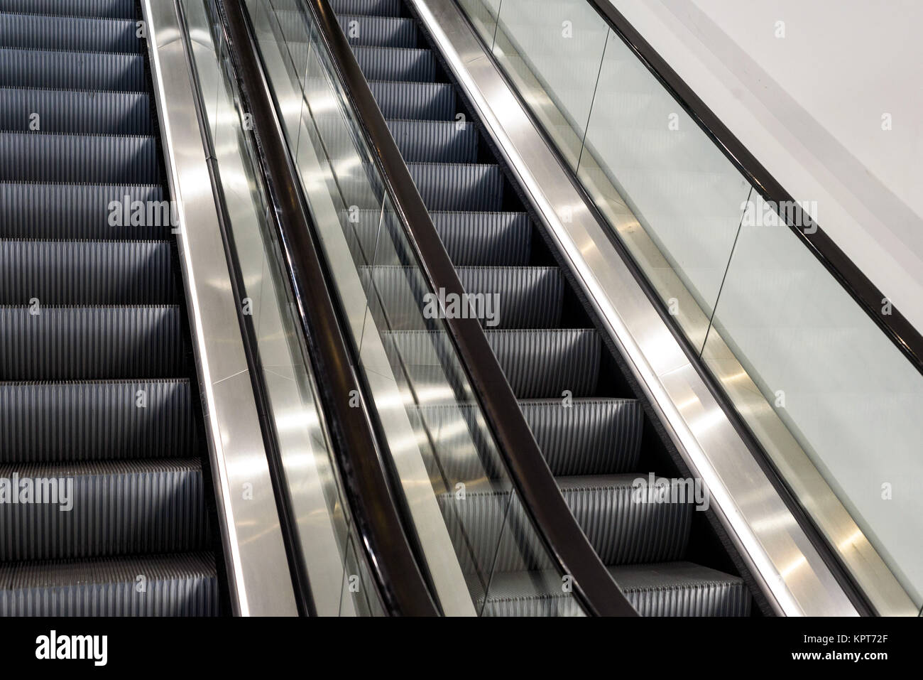 Metal escalator staircases with nobody riding the steps Stock Photo - Alamy