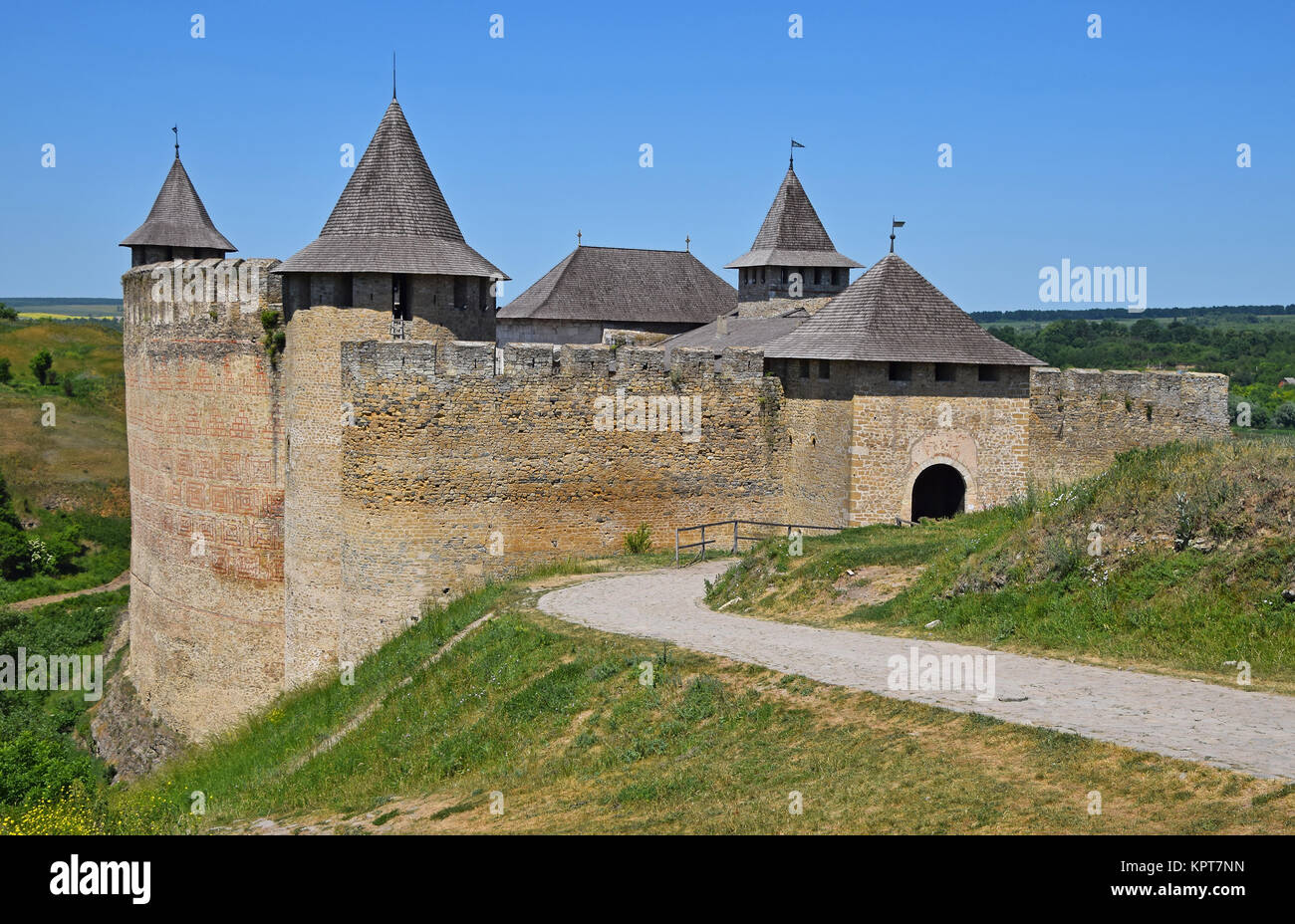 Medieval old fortress castle with ancient stone walls, wooden roofs and ...