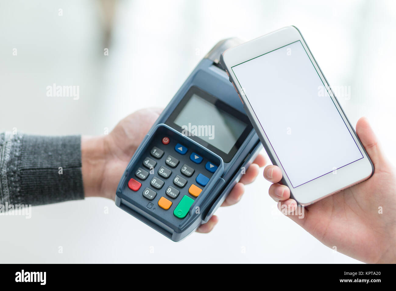 Woman using cellphone for paying the bill Stock Photo - Alamy