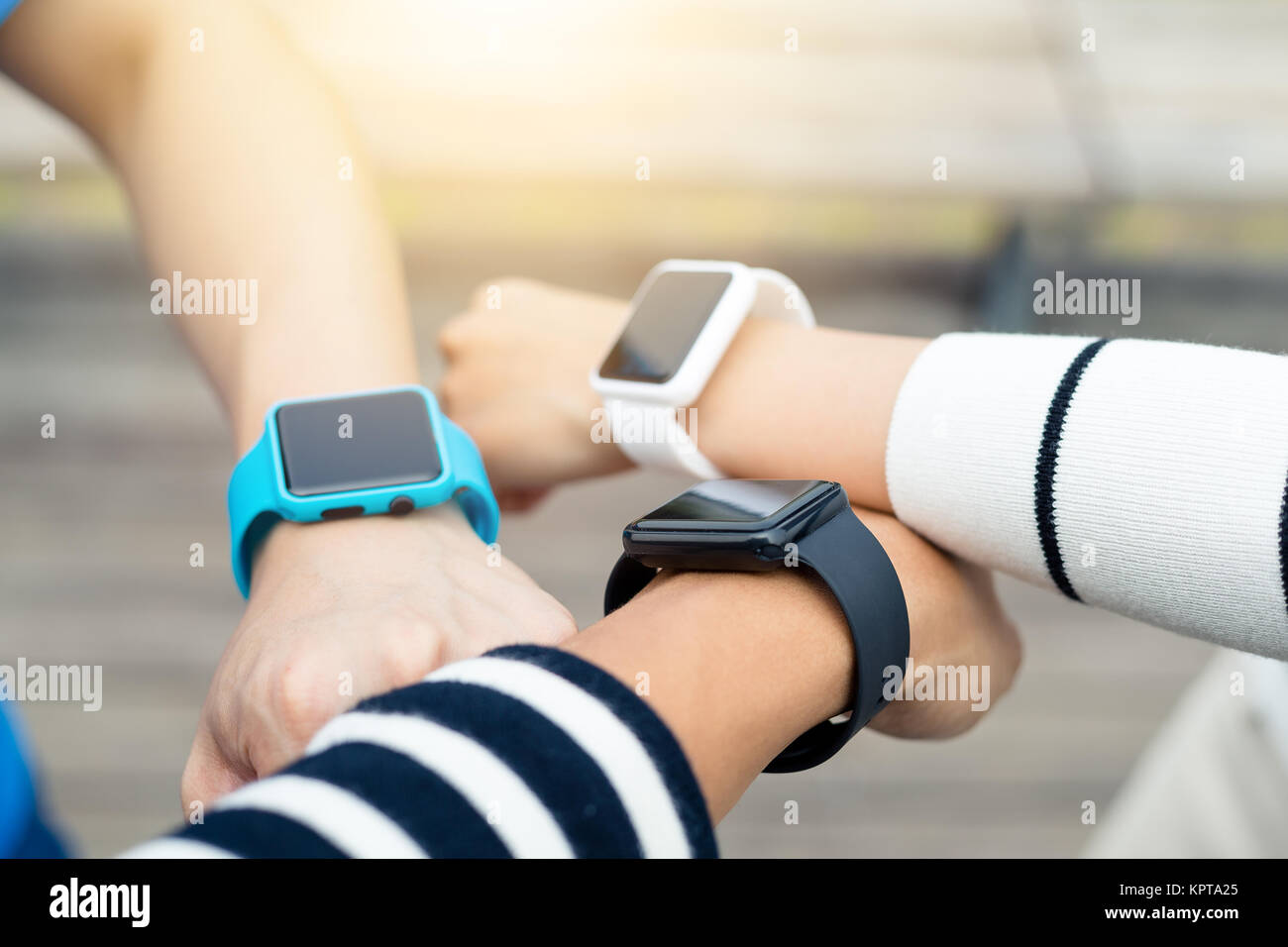 Friends using smart watch together Stock Photo - Alamy