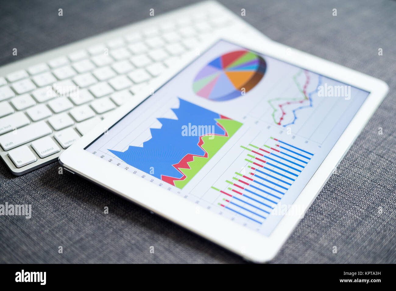 Business charts and diagrams on digital tablet Stock Photo - Alamy