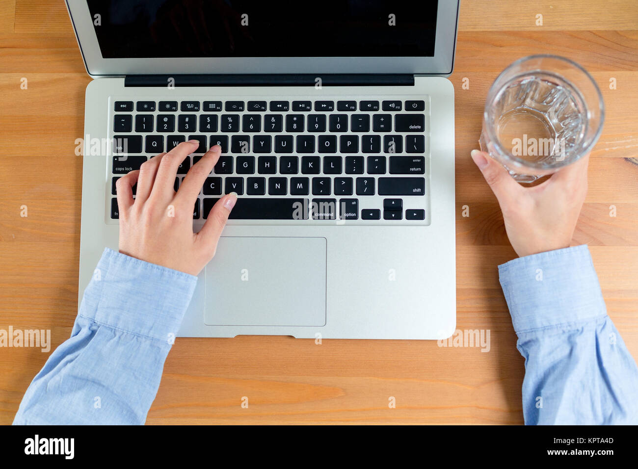 Hands using laptop Stock Photo - Alamy
