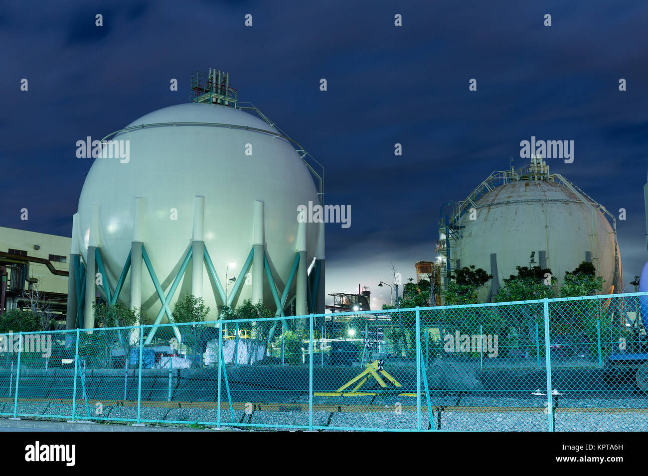 Gas storage tank at night Stock Photo - Alamy