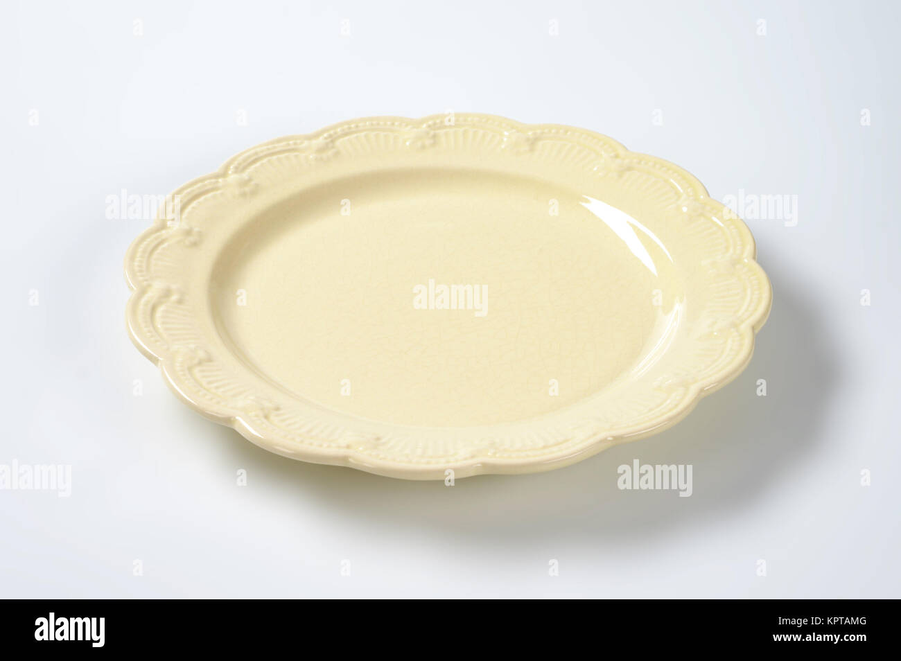 beige plate with embossed rim Stock Photo - Alamy