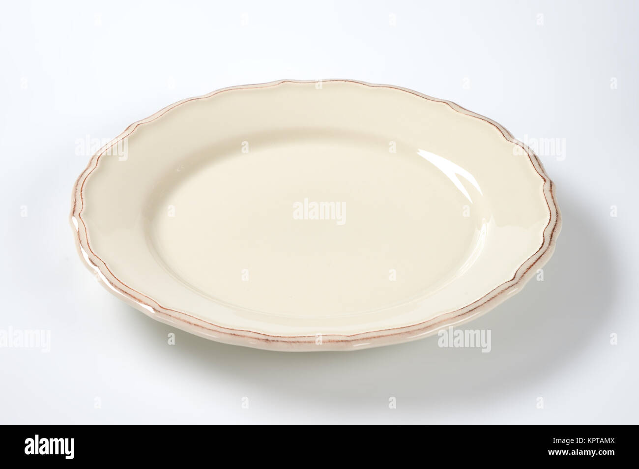 cream dinner plate with decorative edge Stock Photo - Alamy