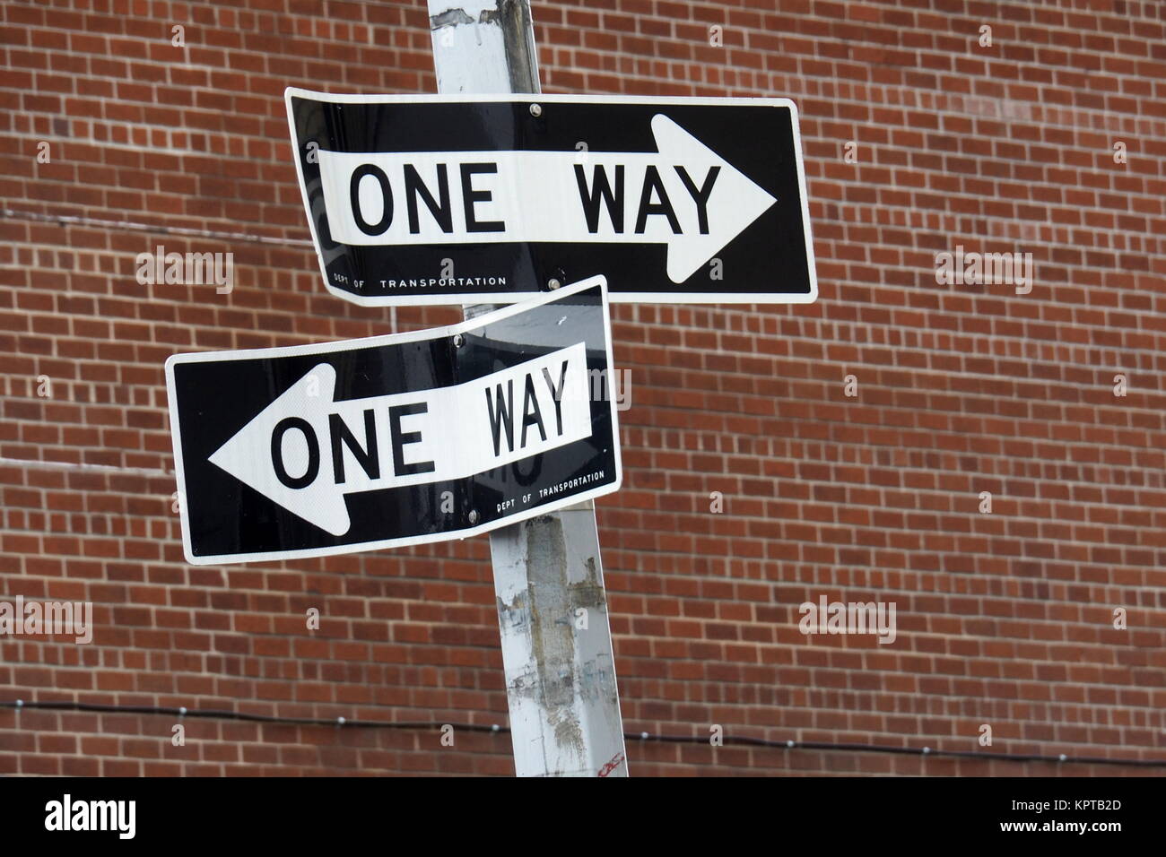 One Way signs fixed to one pole, seemingly pointing in opposite ...