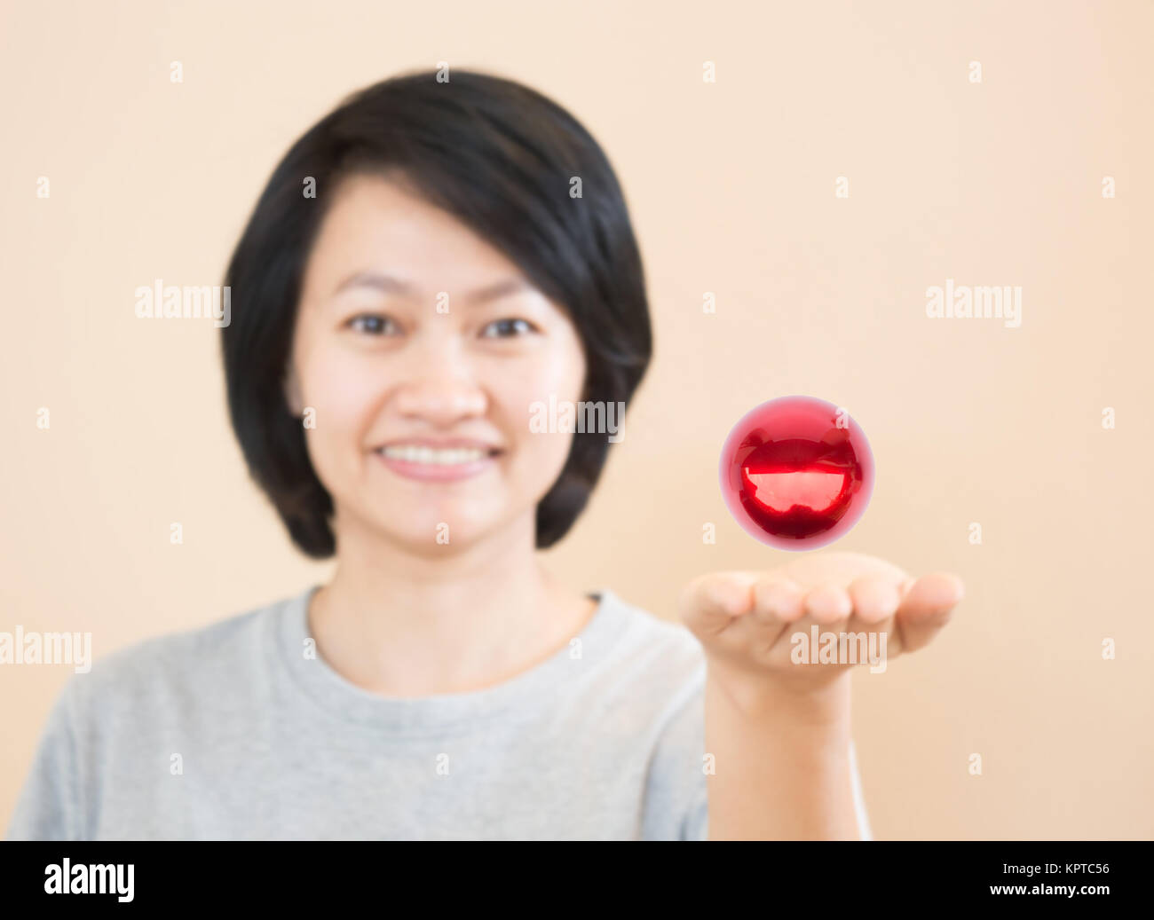 Red magic ball on asian woman hand, stock photo Stock Photo - Alamy