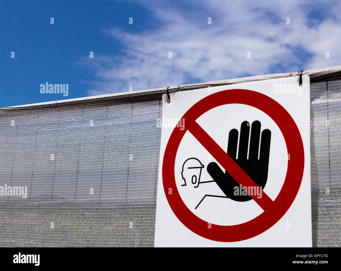 No entry sign on the fence in construction site and blue sky in the ...