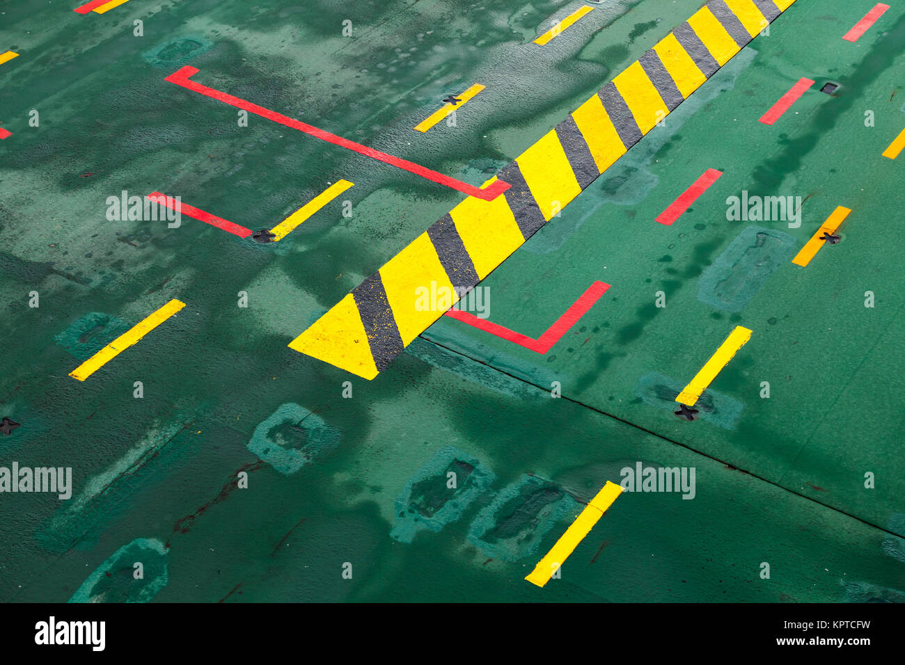 Green ferry deck with colorful marking, shipping transportation ...