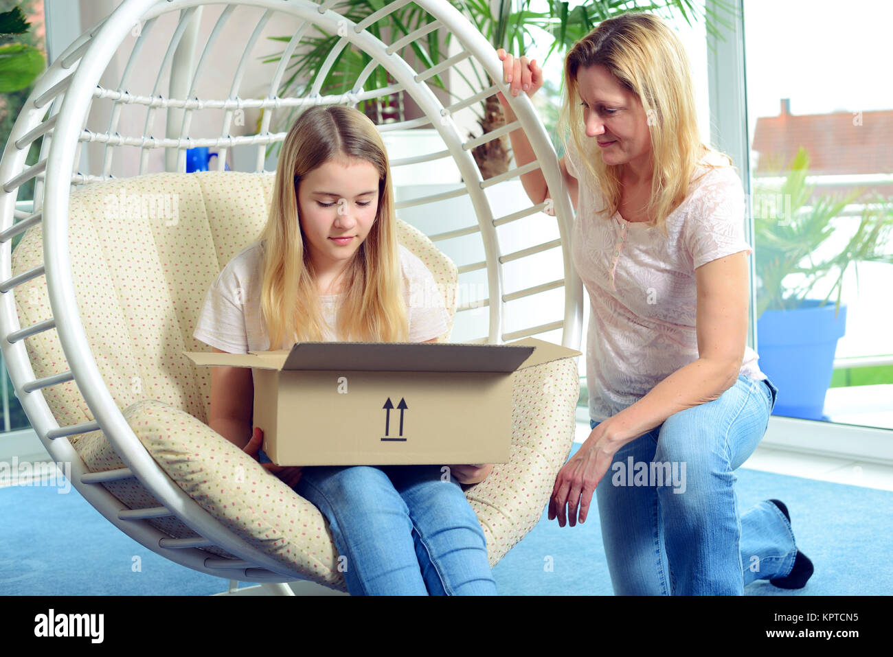 girl and her mother opening a package together Stock Photo - Alamy