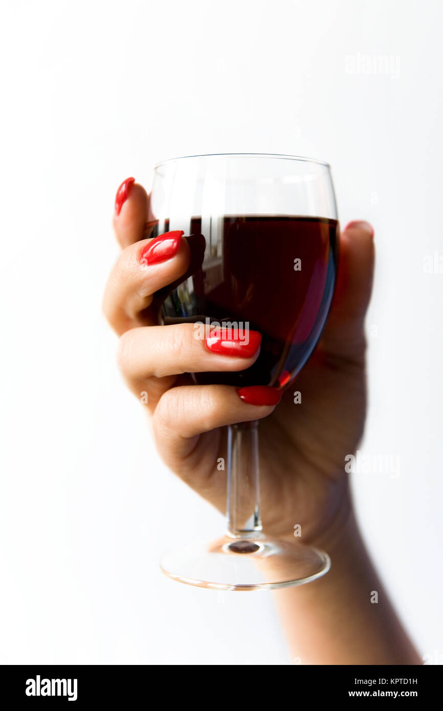 A glass of red wine in a beautiful woman's hand. On a light background ...