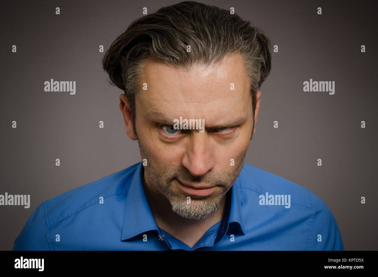 Business man looking crazy on a studio background Stock Photo - Alamy