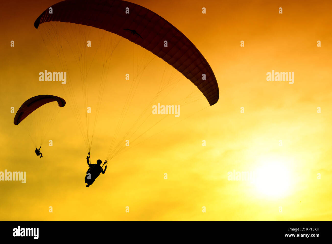 Silhouette of parachute on sunset background Stock Photo - Alamy