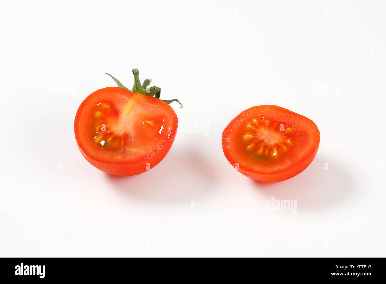 red tomato cut in halves Stock Photo - Alamy