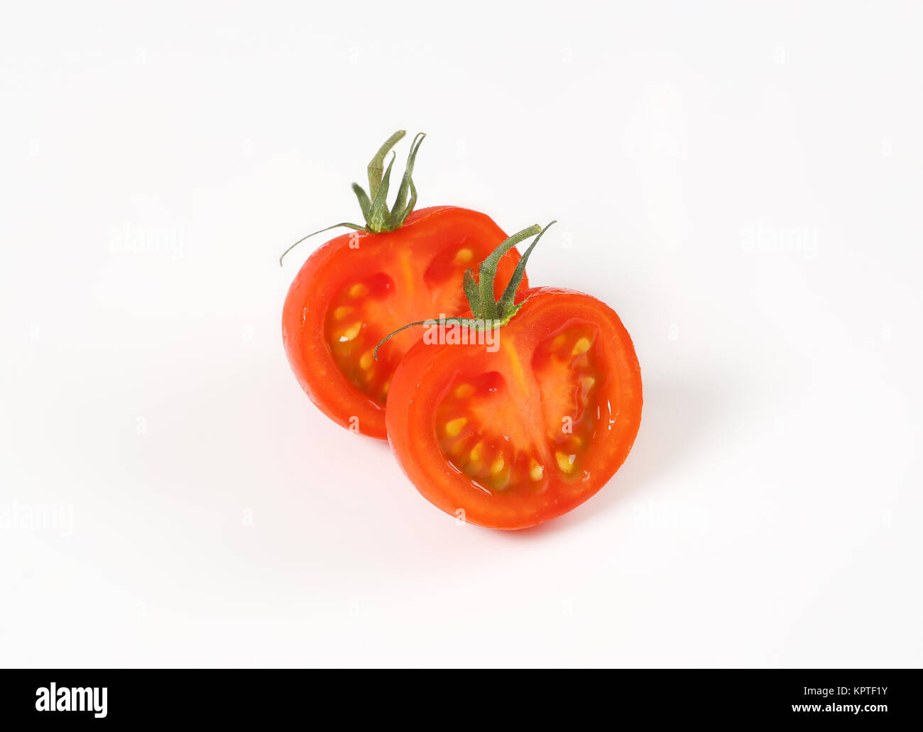 red tomato cut into halves Stock Photo - Alamy