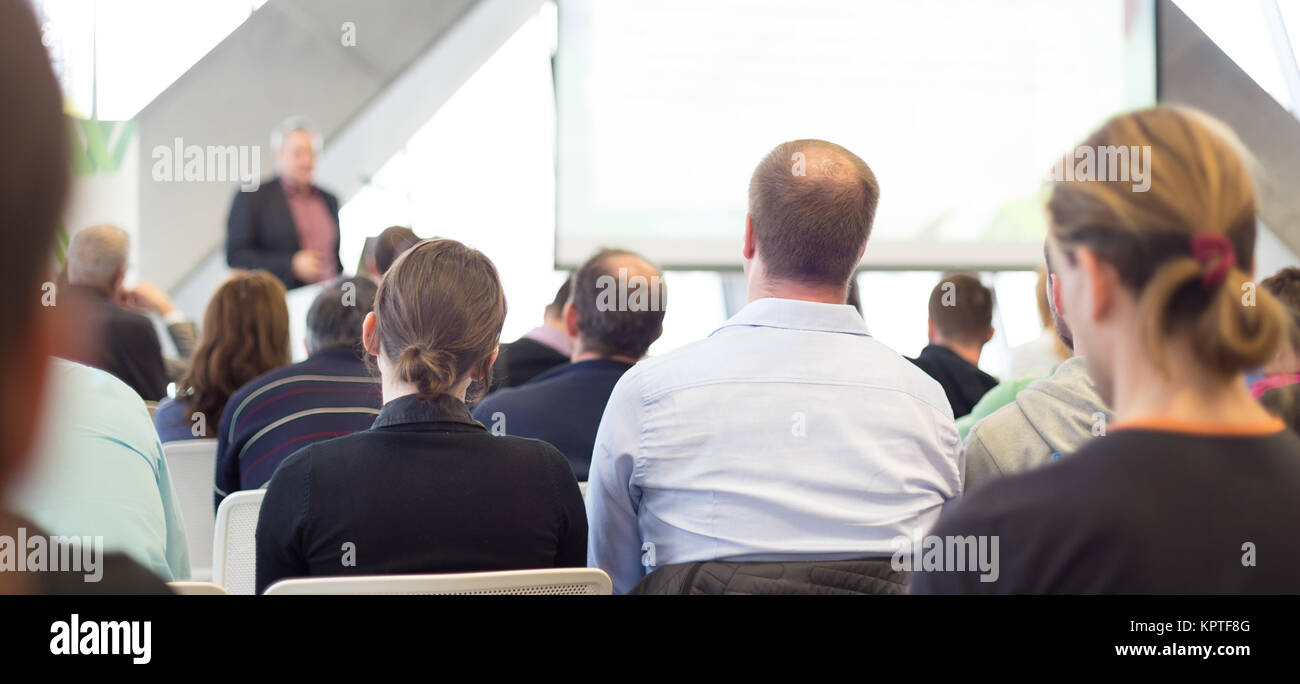 Man giving presentation in lecture hall. Male speeker having talk at ...