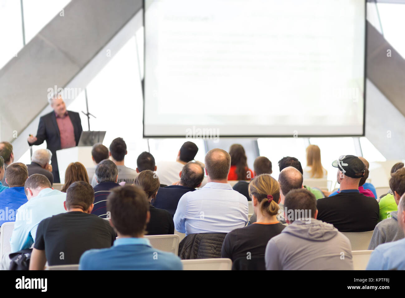 Man giving presentation in lecture hall. Male speeker having talk at ...