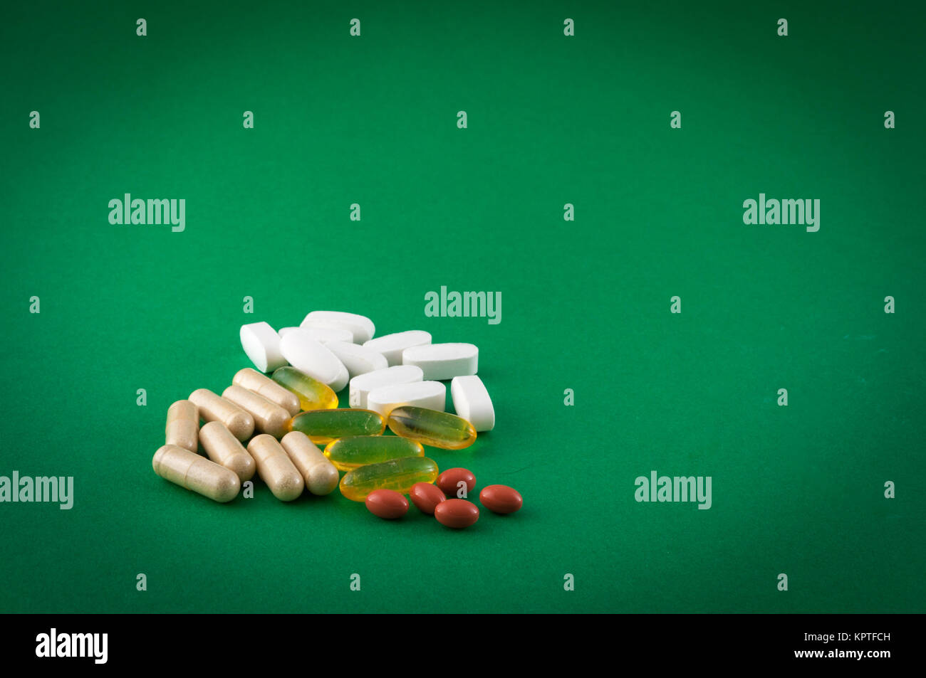 Various pills of supplement on colored background Stock Photo - Alamy