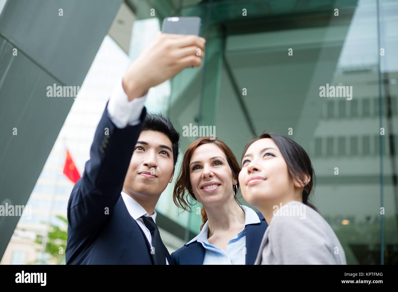 Business people taking self photo together Stock Photo - Alamy