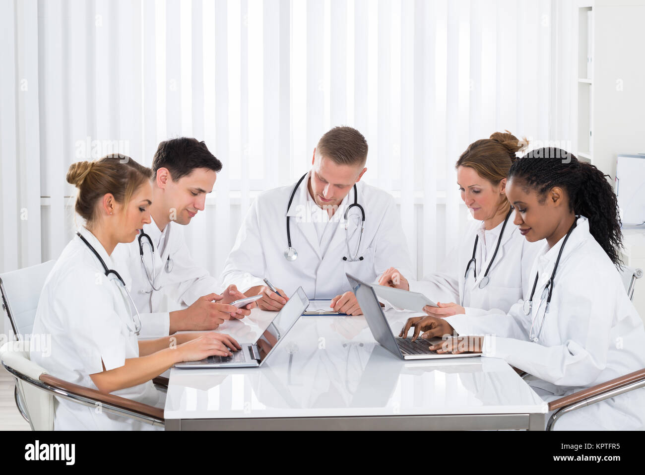 Doctors Using Digital Tablet And Laptop In Hospital Stock Photo - Alamy